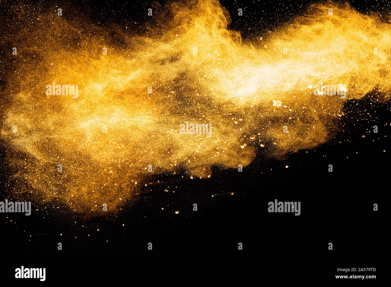 Orange powder explosion on black background. Orange color dust splash ...