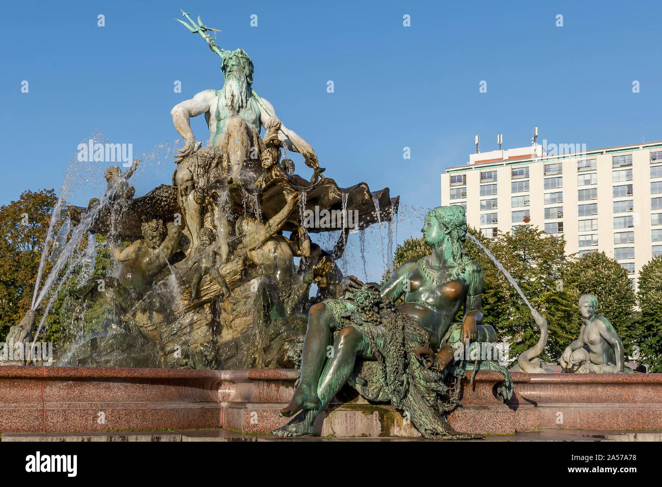 The beautiful Neptune Fountain, in German Neptunbrunnen, illuminated by ...