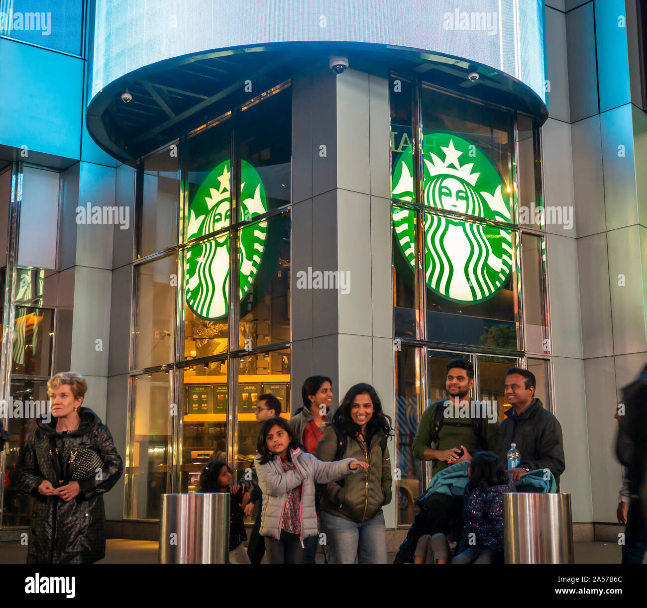 Passer-by walk past a Starbucks coffee shop in Midtown Manhattan in New ...