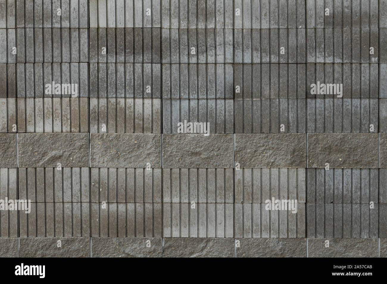 Gray relief rectangular street paving stone tile on building wall, for ...