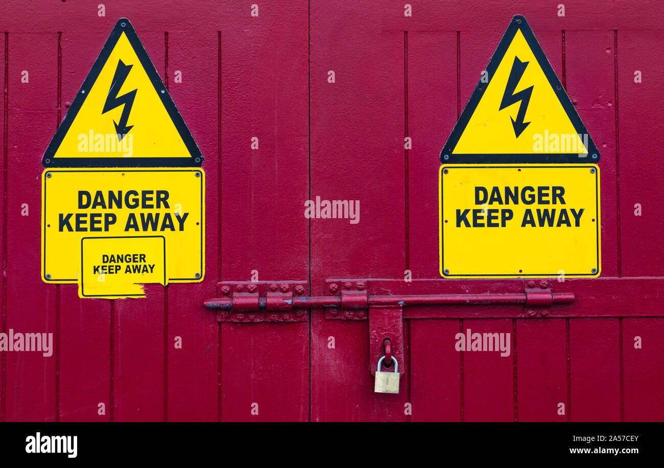 Warning : High voltage. Keep away. Sign in locked wooden door Stock ...