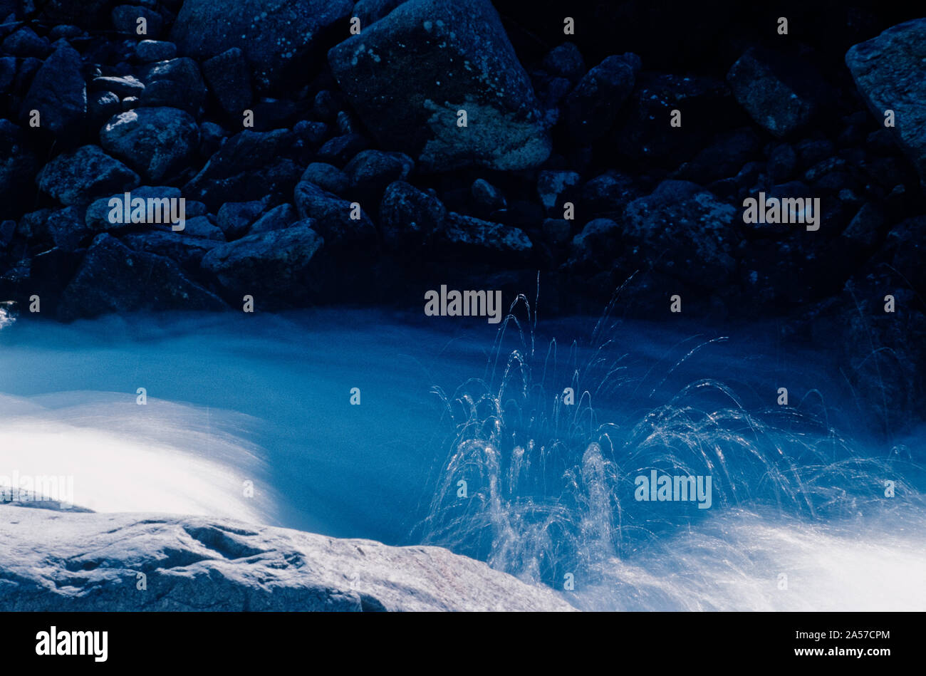 Water splashing over rocks in a stream Stock Photo - Alamy