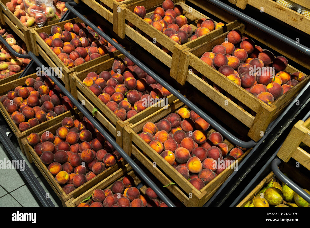 Diagonal view of wooden lug boxes with soft and mellow peaches on ...