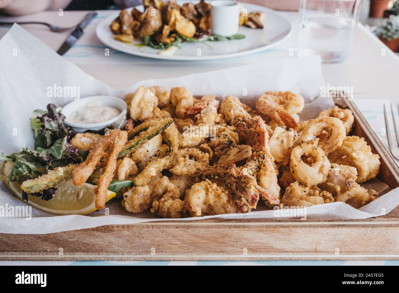 Frito misto (varied battered deep fried seafood) served on a wooden ...