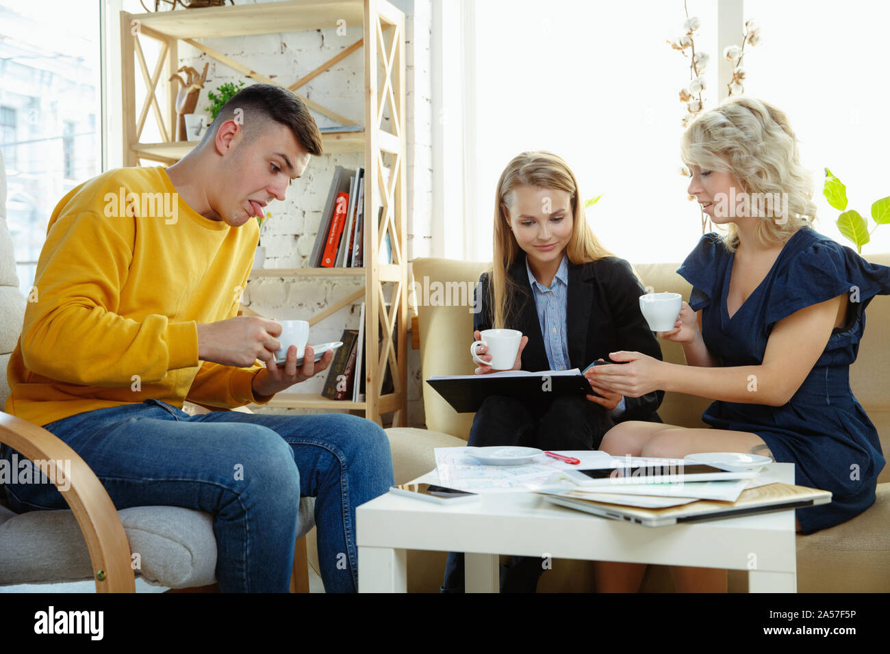 Interior designer working with young couple. Lovely family and ...