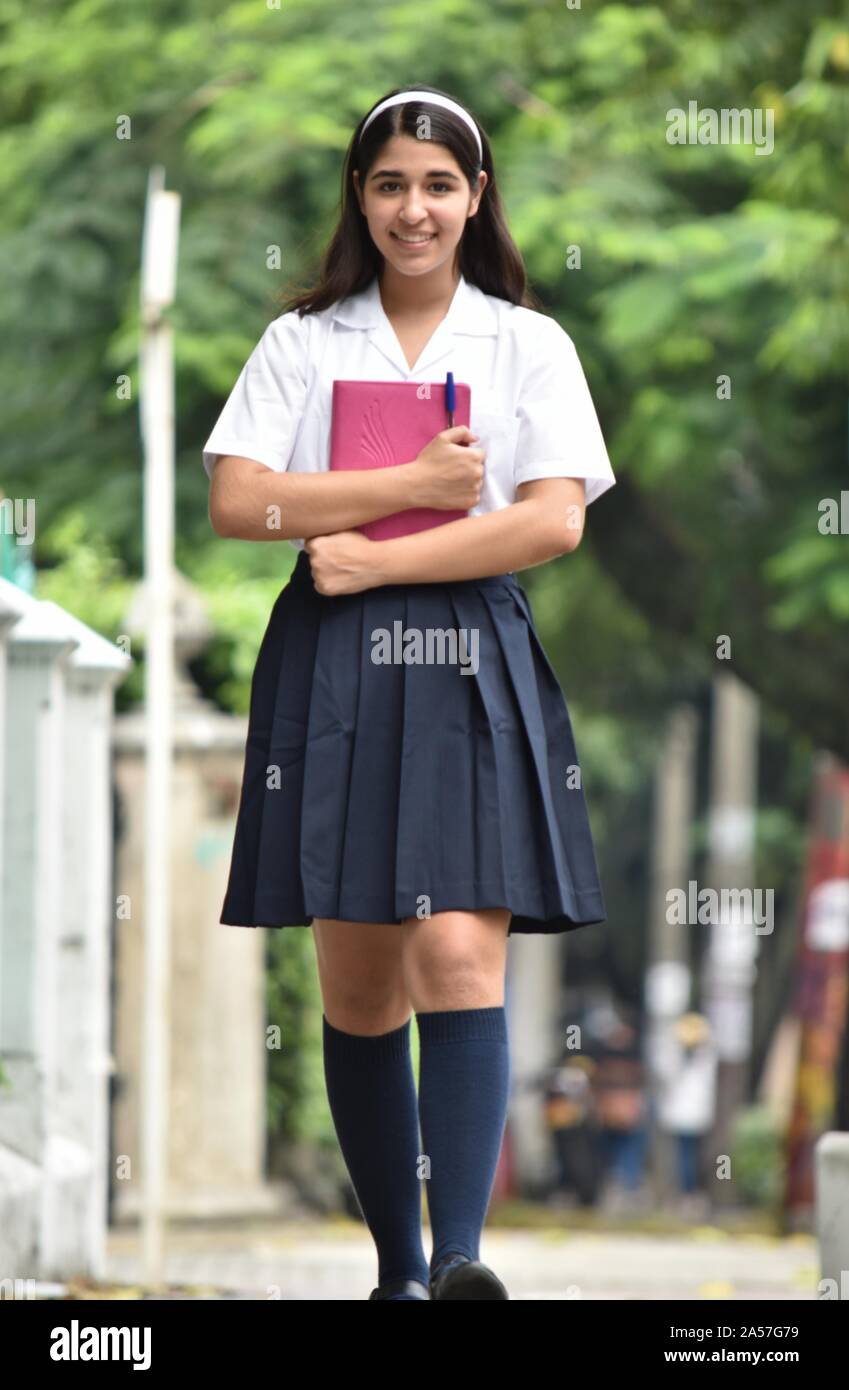Female Student Walking Wearing Uniform With Notebook Stock Photo - Alamy