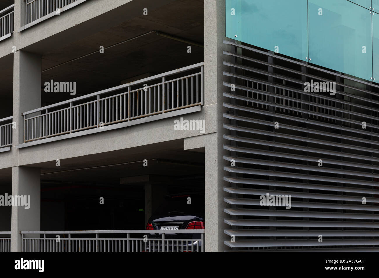 Low angle view of high building facade with metal side wall and ...