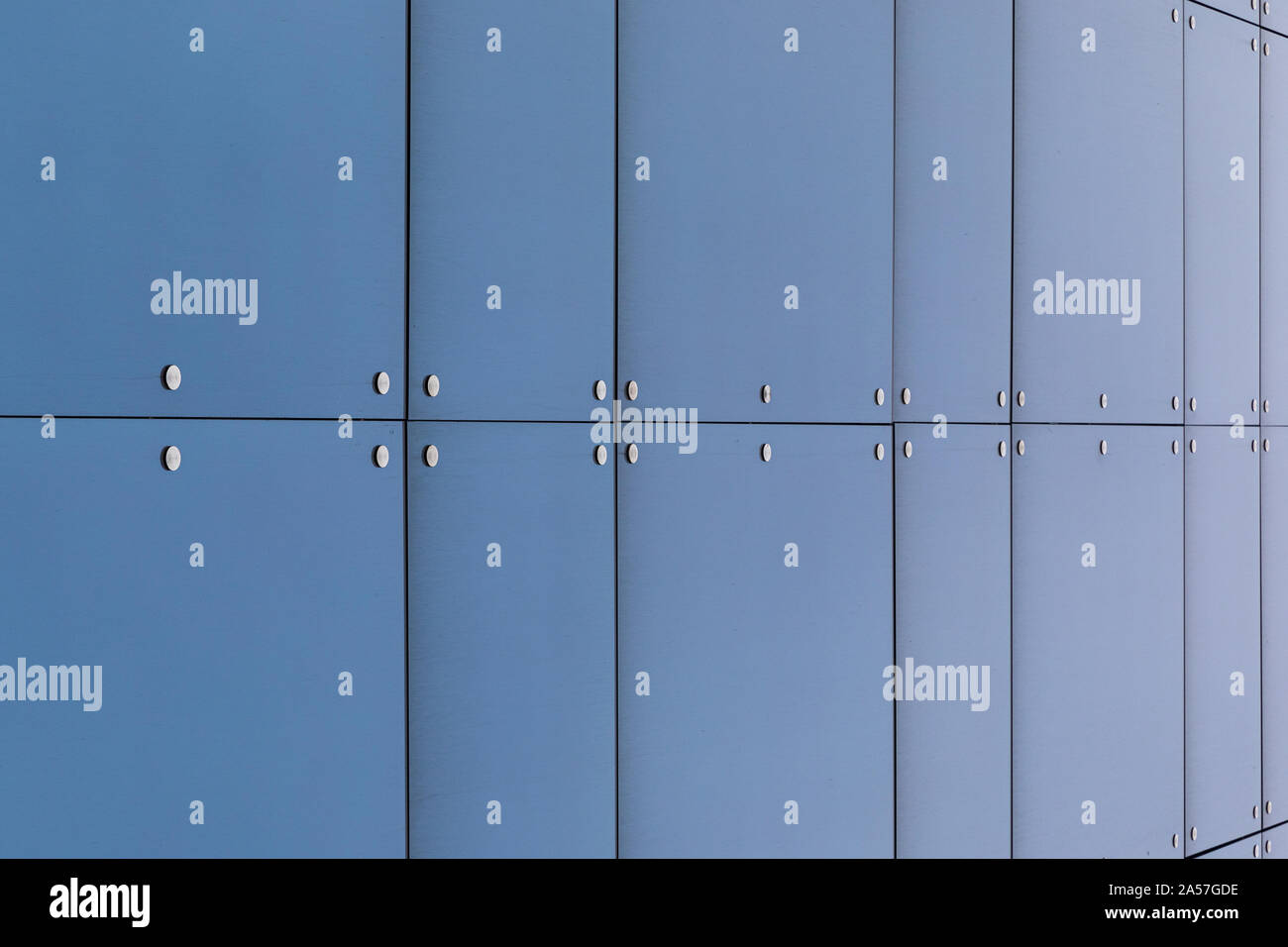 Front view of smooth blue panel on business centre facade, exterior ...