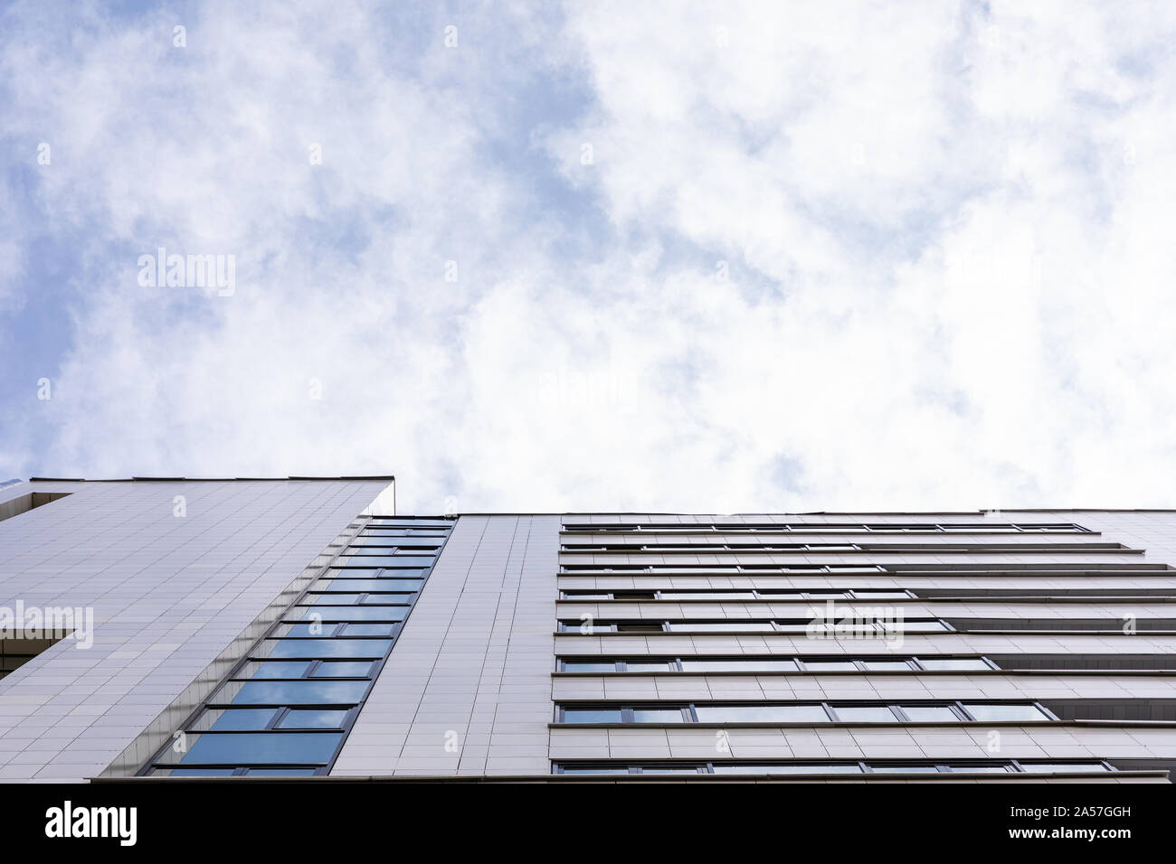 Ground view of tall building with balconies and tiled facade Stock ...