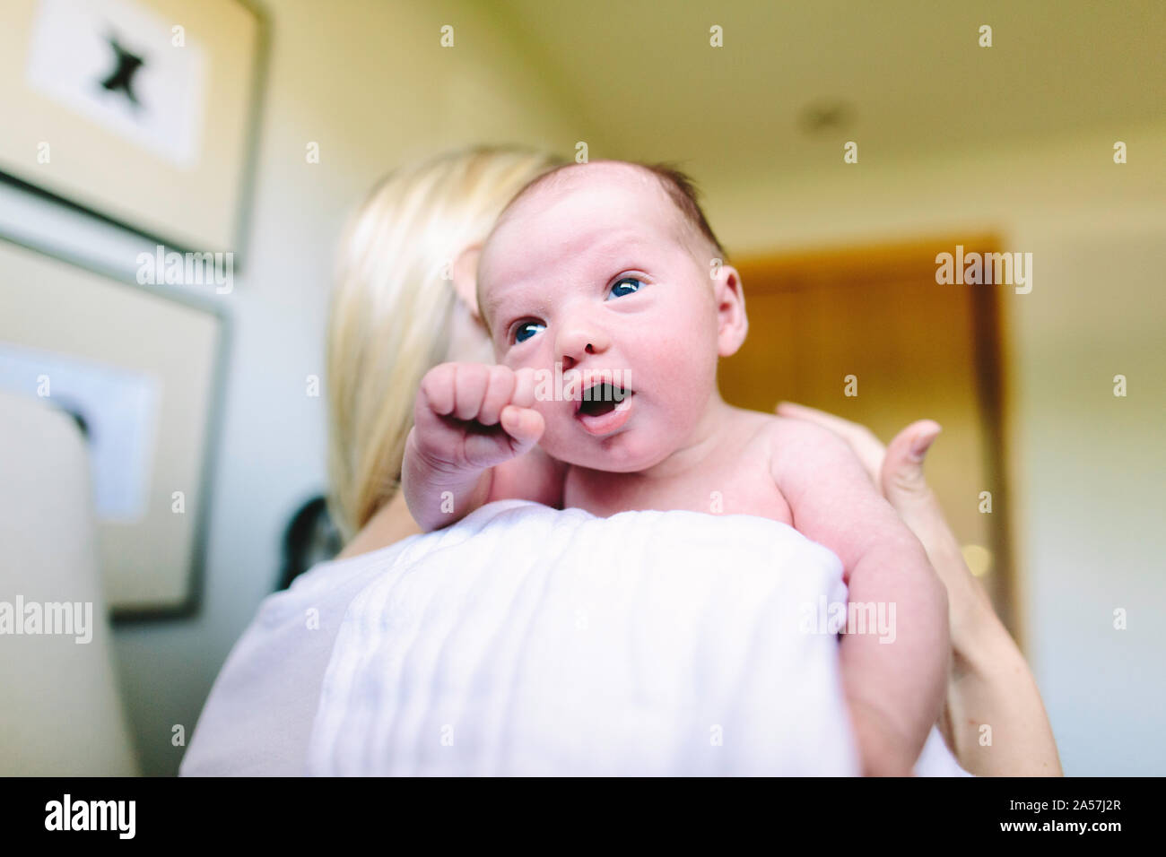 Over the shoulder view of a newborn baby boy in his mother's arms Stock ...