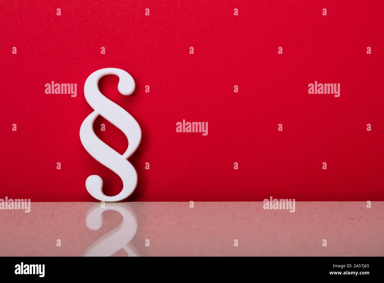 White Paragraph Sign Leaning On Red Wall Stock Photo - Alamy