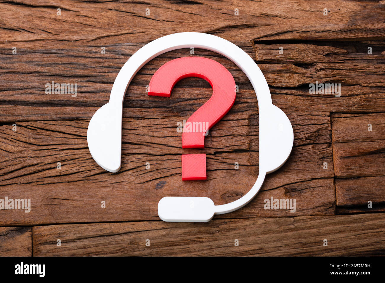Customer Support Concept Headphones And Question Mark On Wooden Desk ...
