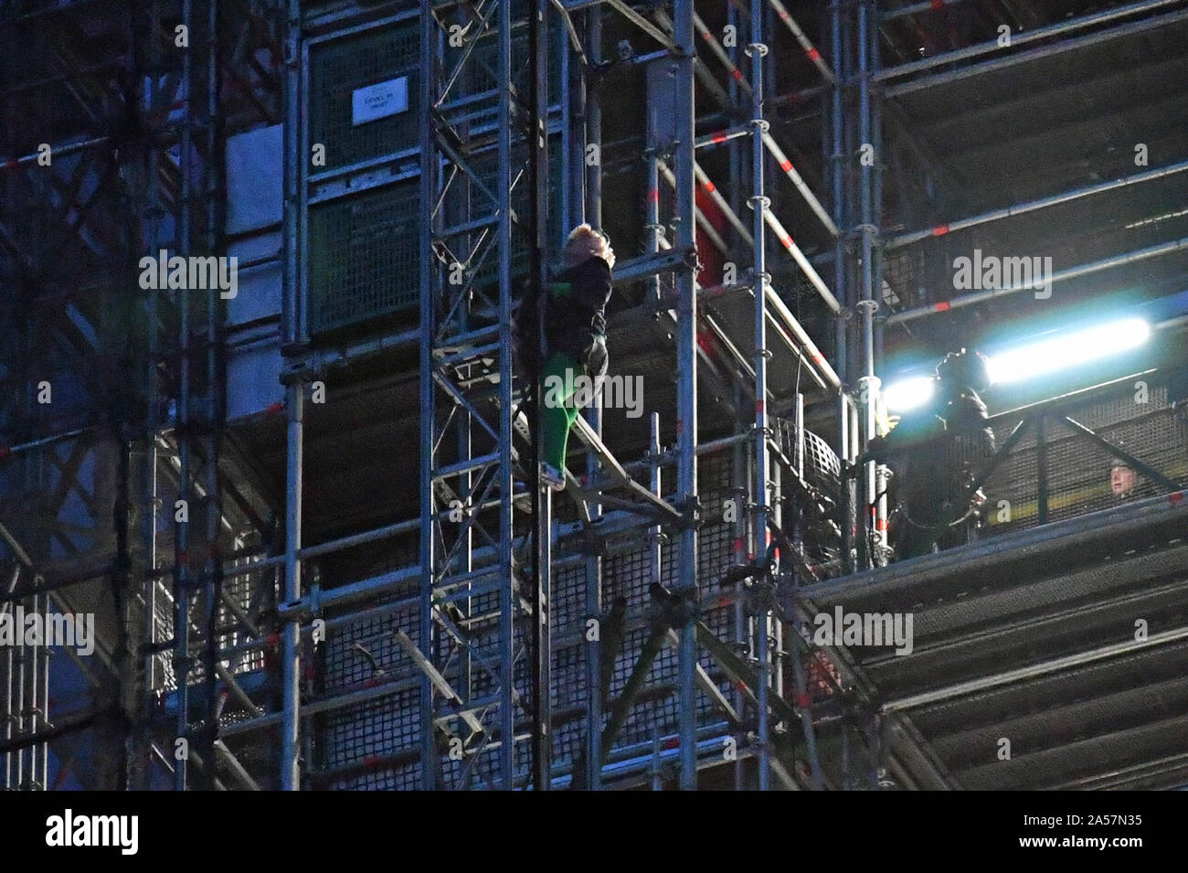 An Extinction Rebellion protester who has scaled the scaffolding ...