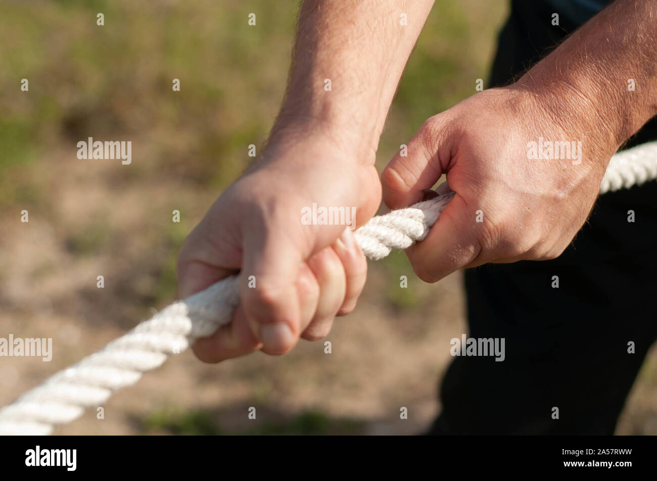 strong male hands firmly hold or pull the rope outdoor Stock Photo - Alamy