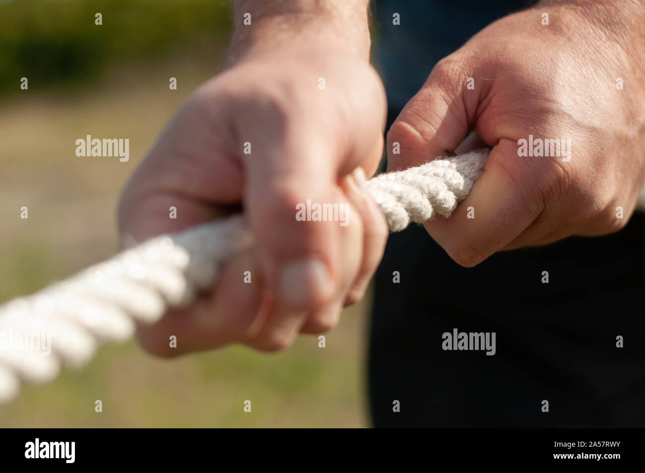 strong male hands firmly hold or pull the rope outdoor Stock Photo - Alamy