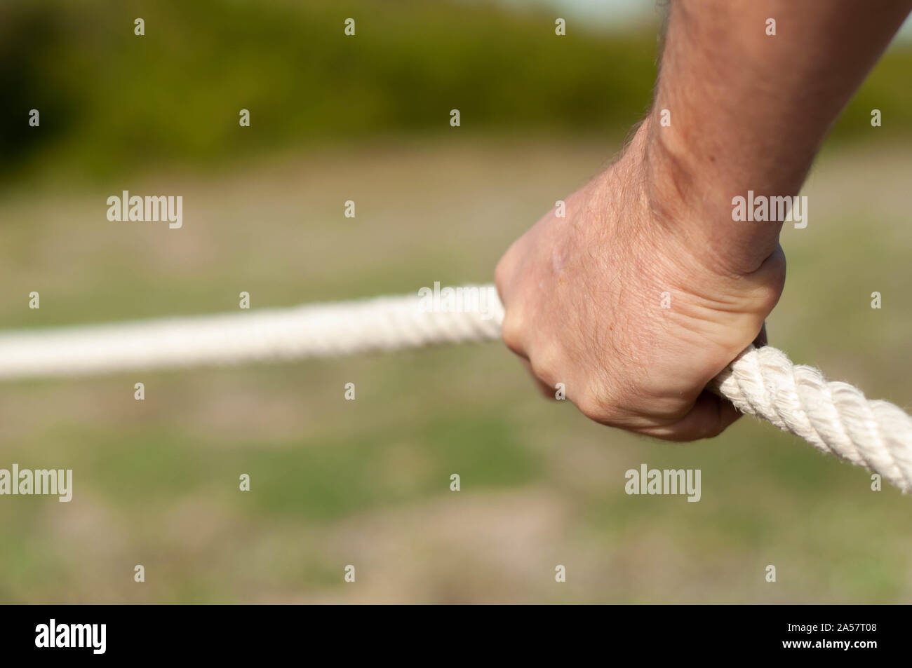 strong male hands firmly hold or pull the rope outdoor Stock Photo - Alamy