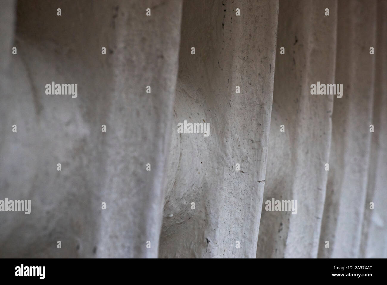 Close-up background image of an old painted cast iron radiator, shot ...