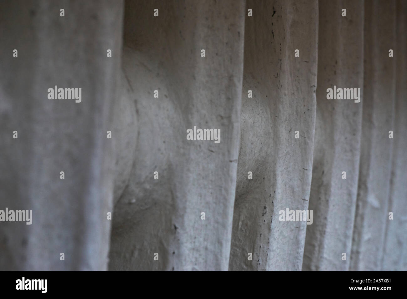 Close-up background image of an old painted cast iron radiator, shot ...