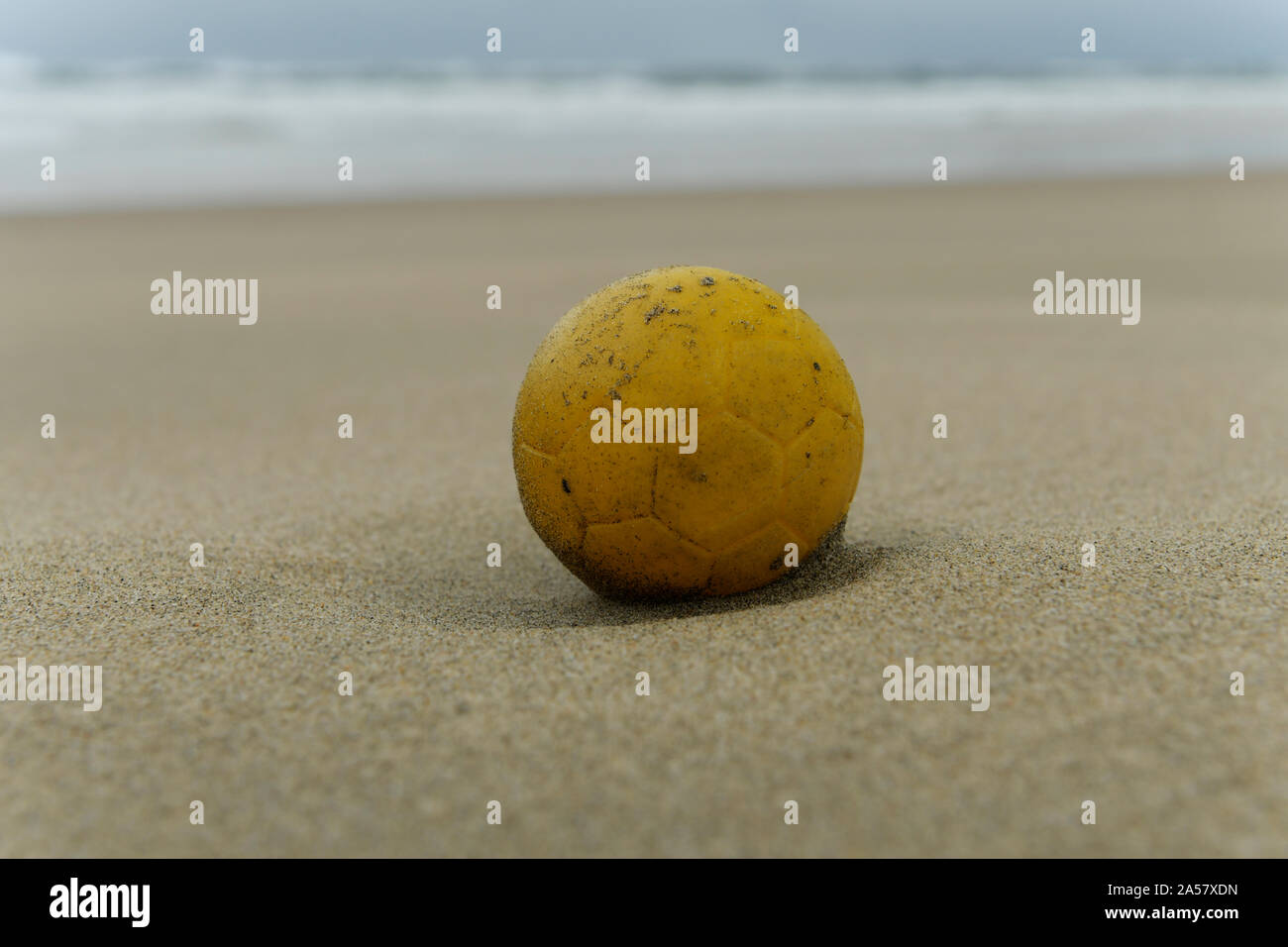 Yellow toy soccer ball washed up on beach, object, close up, plastic ...