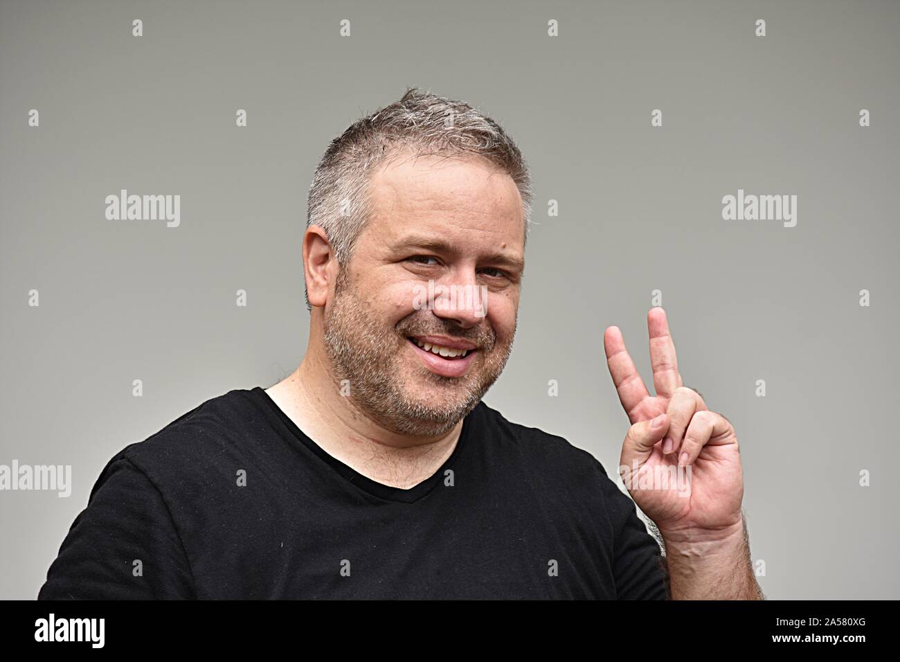 An Unshaven Male And Peace Sign Stock Photo - Alamy