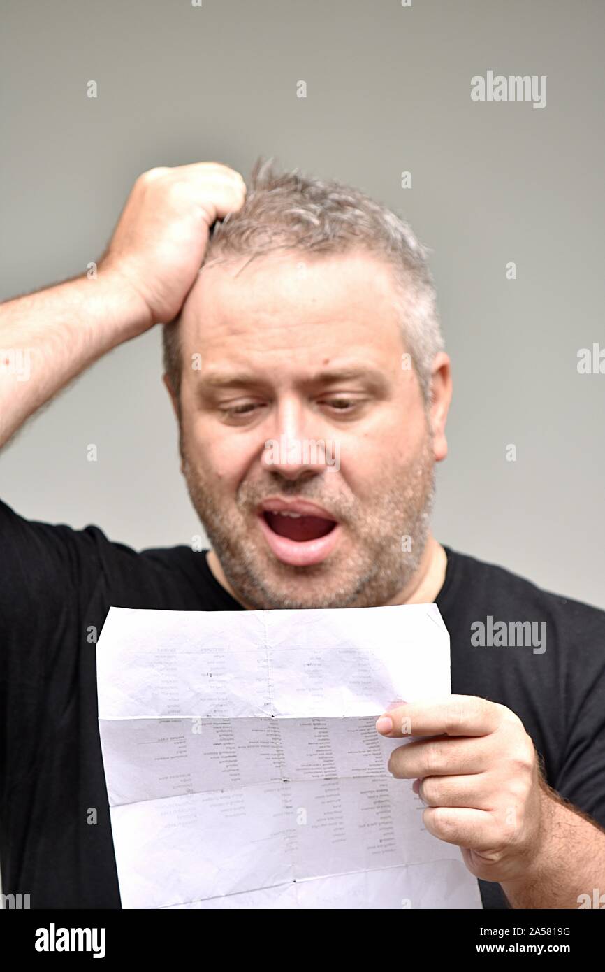 Confused Overweight Man Reading Documents Stock Photo - Alamy