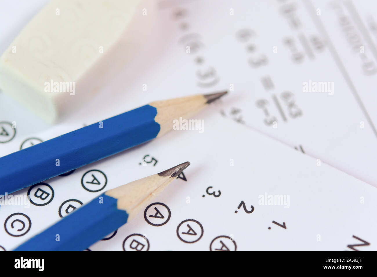 Pencil and eraser on answer sheets or Standardized test form with ...