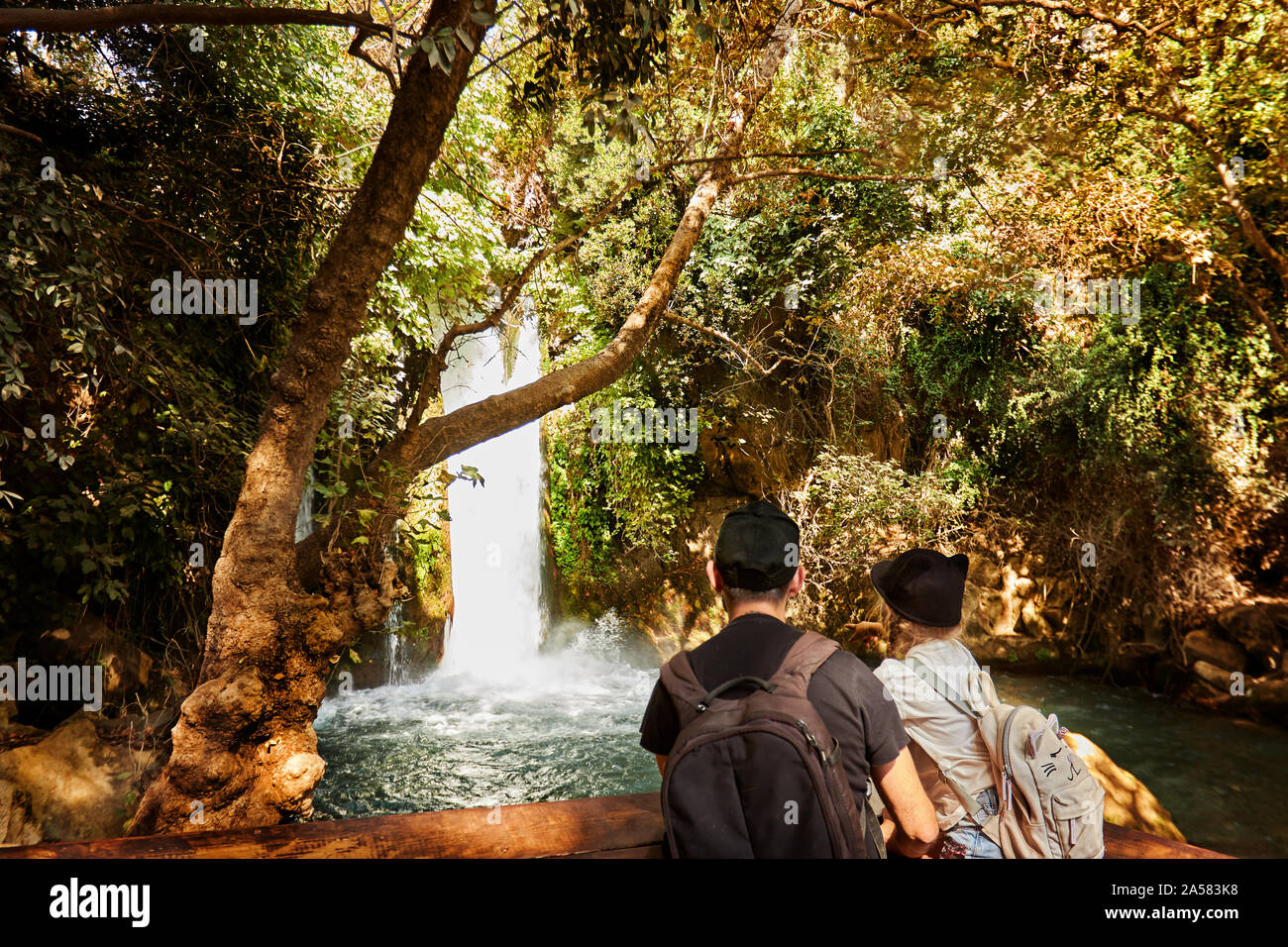 father and little daughter travel and explore the waterfall. Dad and ...