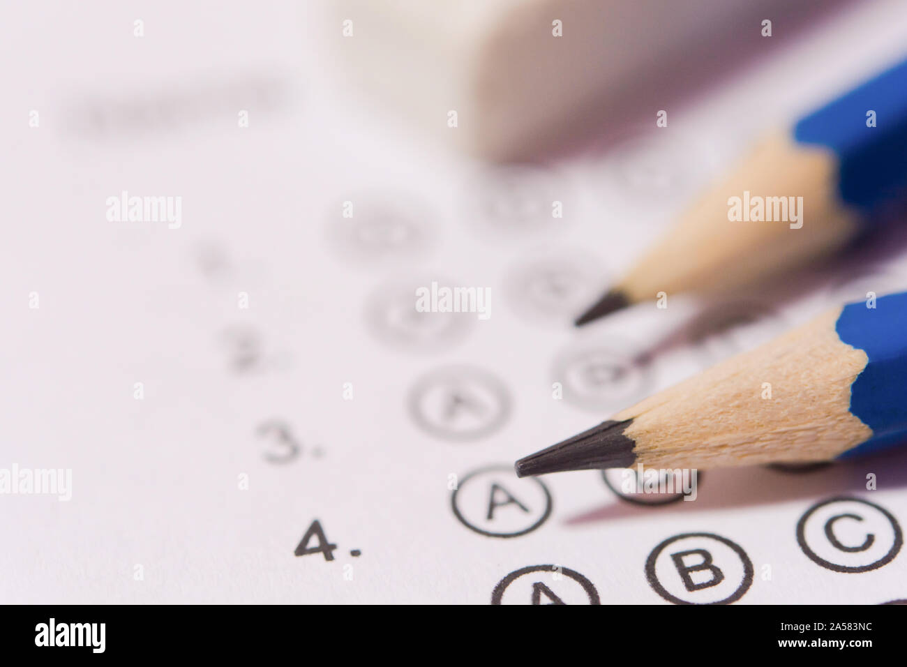 Pencil and eraser on answer sheets or Standardized test form with ...
