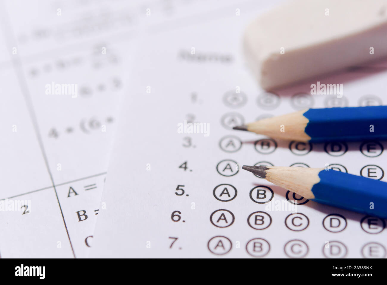 Pencil and eraser on answer sheets or Standardized test form with ...