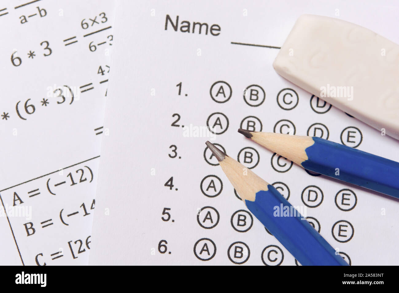 Pencil and eraser on answer sheets or Standardized test form with ...