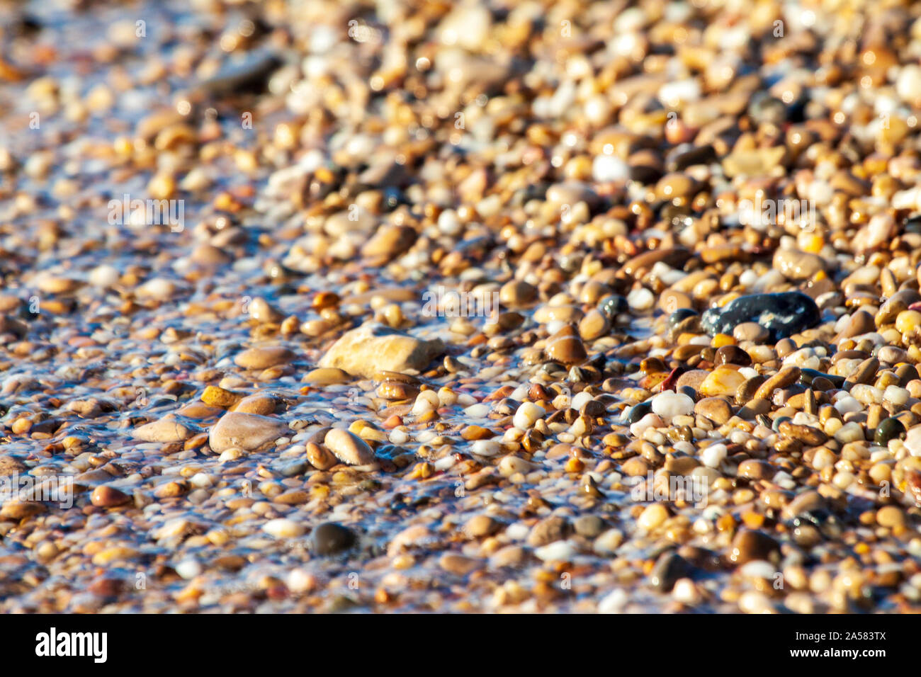 sea pebbles colored granite on the beach background stones. The shore ...