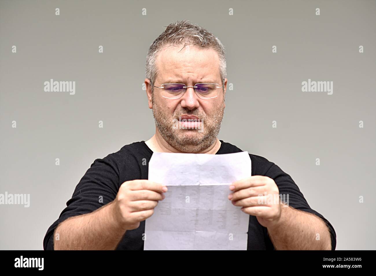 Confused Overweight Man Reading Documents Stock Photo - Alamy