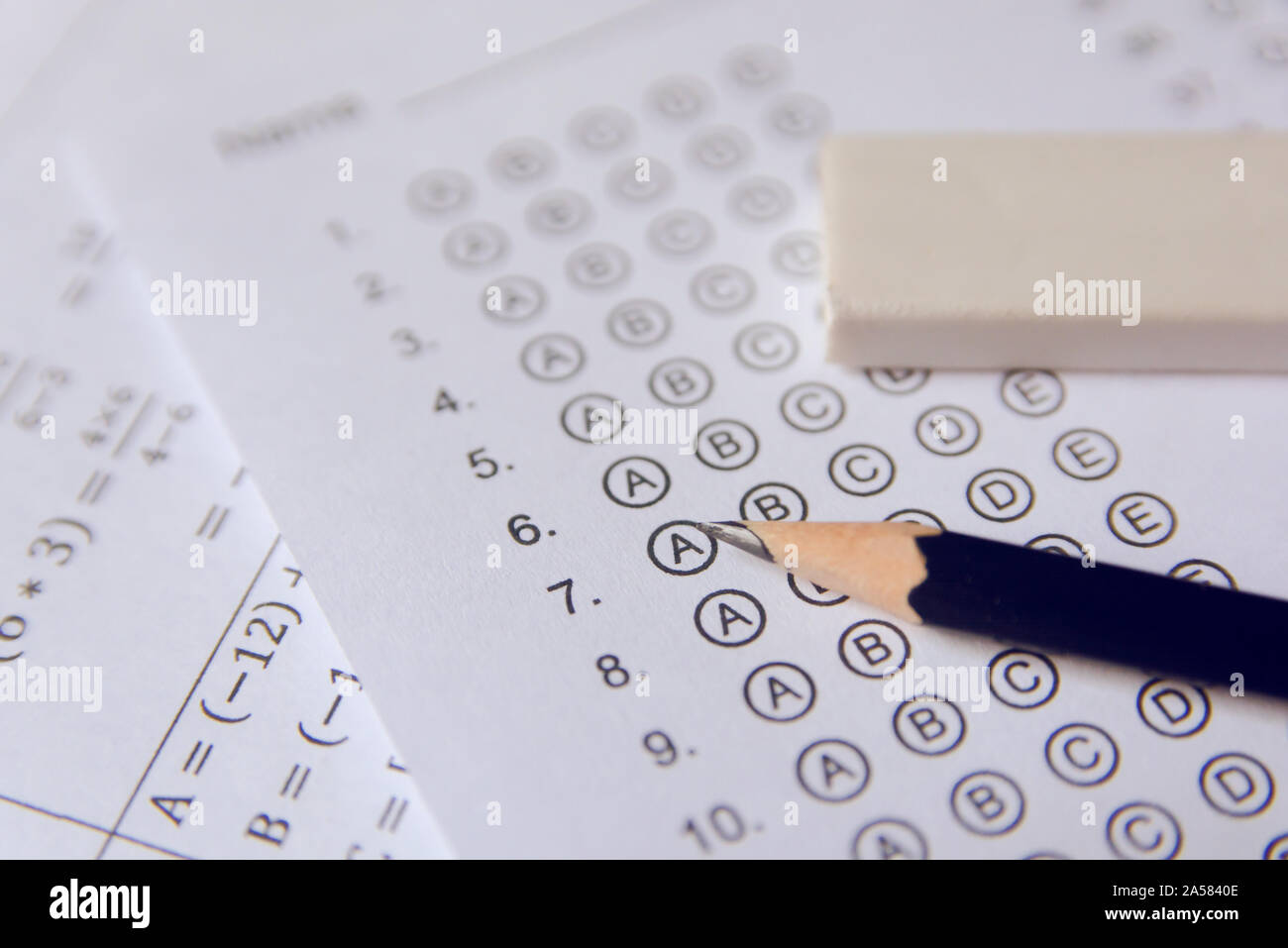 Pencil and eraser on answer sheets or Standardized test form with ...
