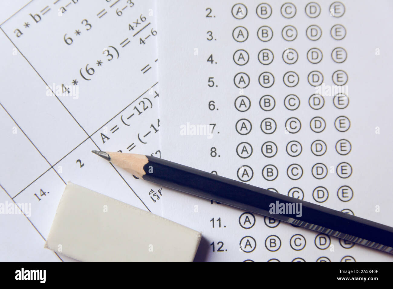 Pencil and eraser on answer sheets or Standardized test form with ...
