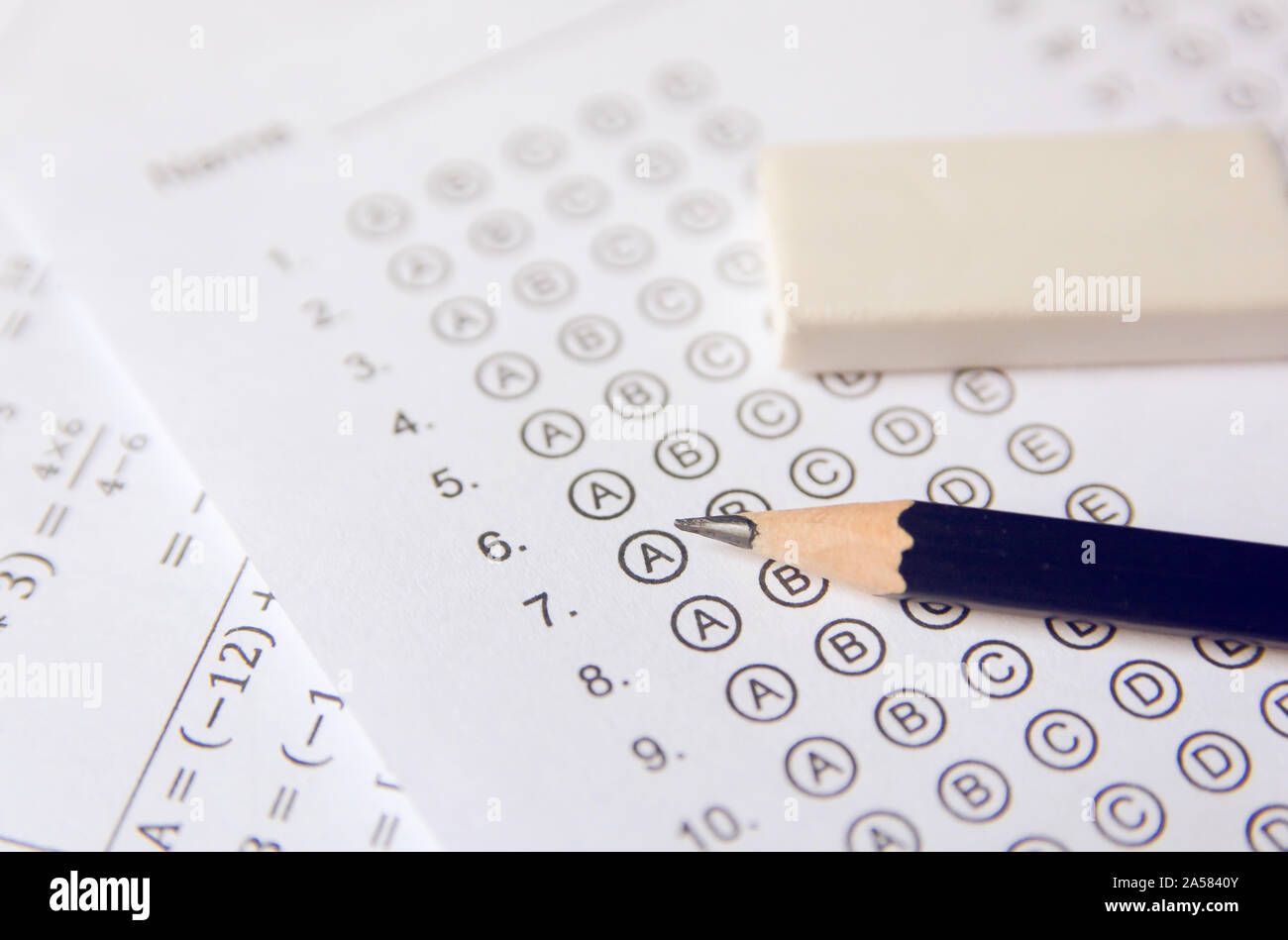 Pencil and eraser on answer sheets or Standardized test form with ...
