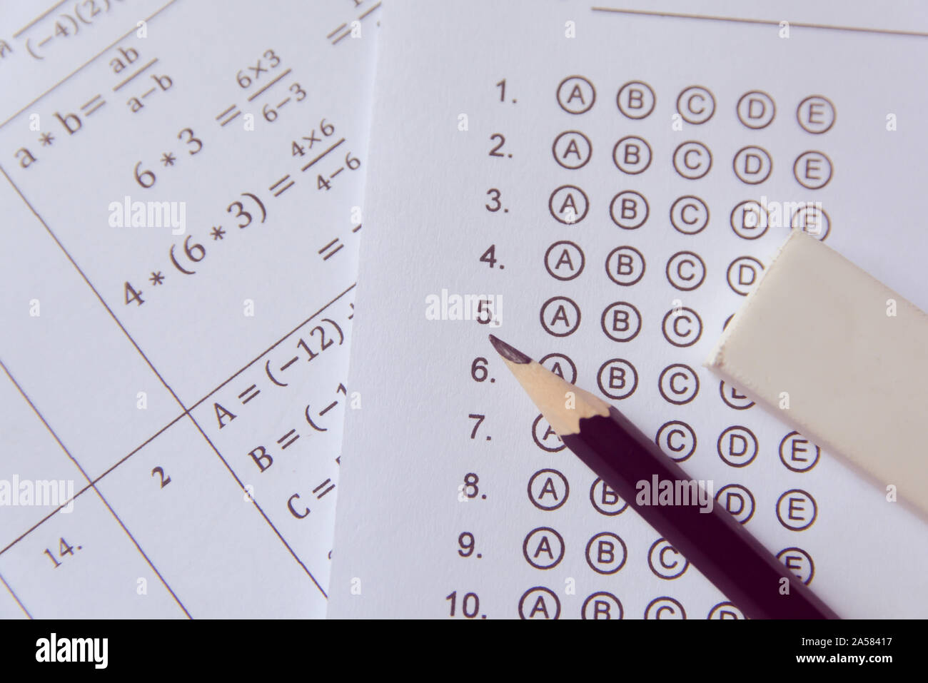 Pencil and eraser on answer sheets or Standardized test form with ...