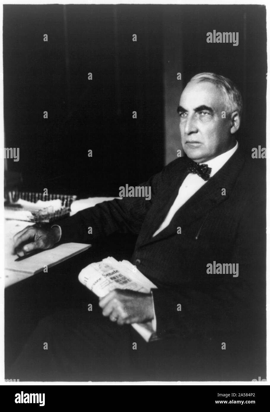 Warren G. Harding, three-quarter length portrait, seated at desk ...