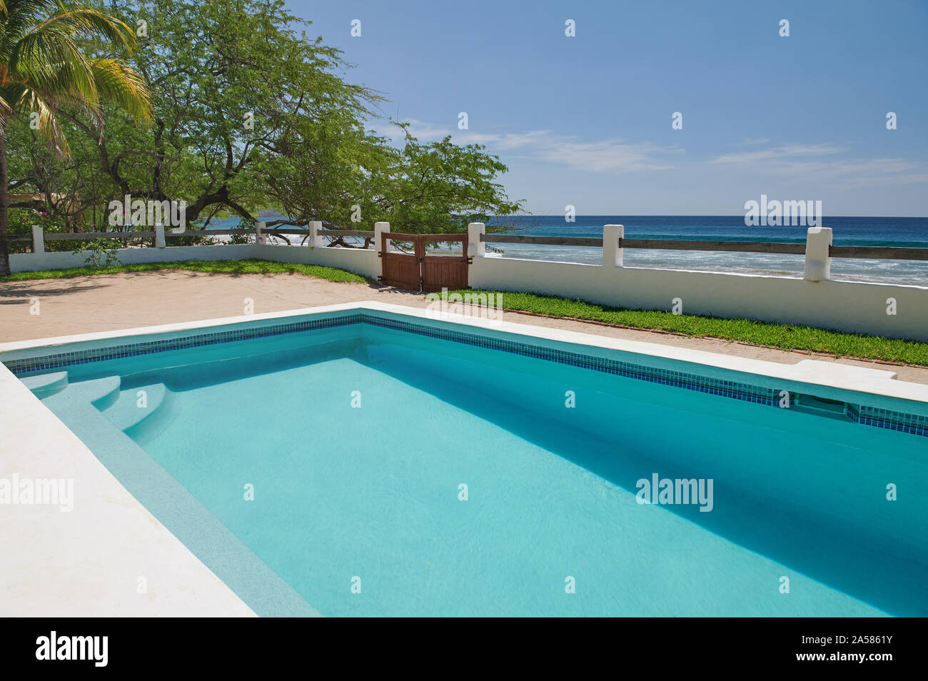 Blue pool background. Swimming pool next to ocean Stock Photo - Alamy