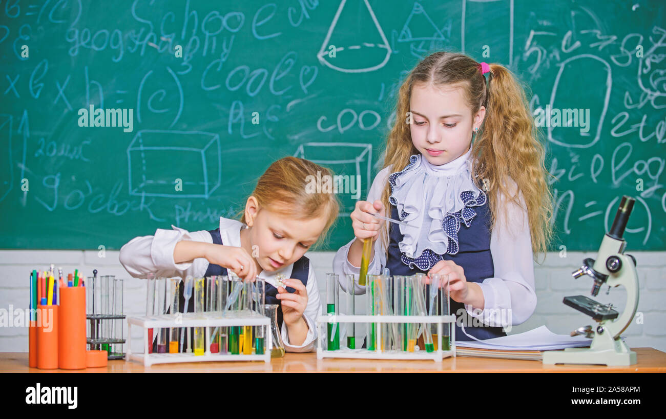 At chemistry class. Little pupils holding test tubes in laboratory ...