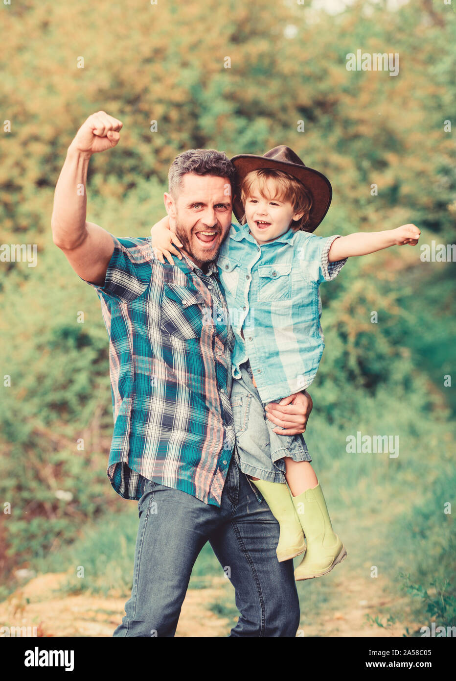 Power being father. Child having fun cowboy dad. Rustic family. Growing ...