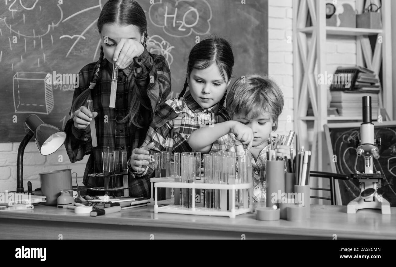 Pupil looking through microscope at the elementary school ...