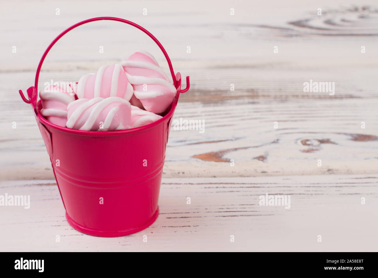 Small red bucket with marshmallows Stock Photo - Alamy