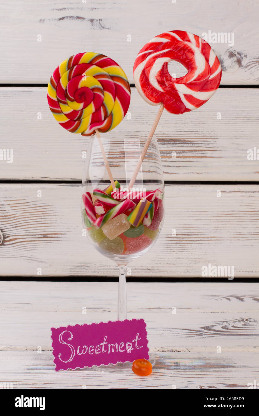 Colorful candies and lollipops in wine glass Stock Photo - Alamy