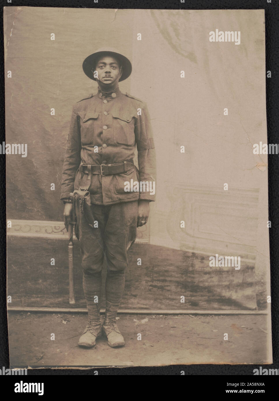 Unidentified African American military policeman in uniform and helmet ...