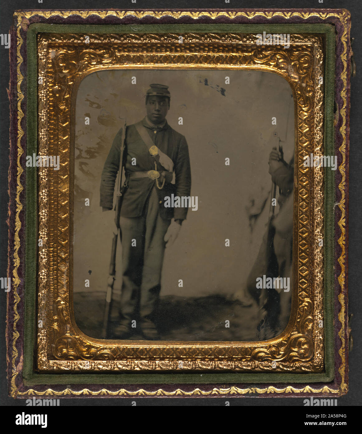 Unidentified African American soldier in Union uniform and gloves with ...
