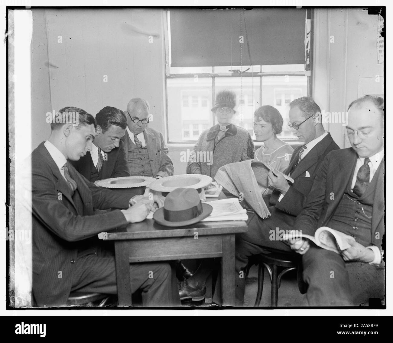 Small group of people sitting Black and White Stock Photos & Images - Alamy