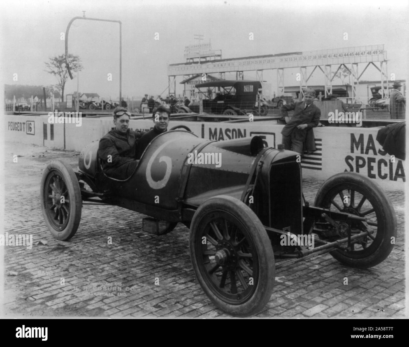 Unidentified men seated in racing cars Stock Photo - Alamy