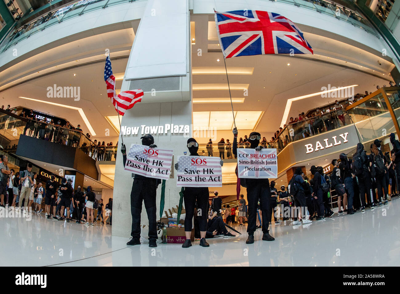 Hong Kong protestors wave British and American flags in protest in a ...