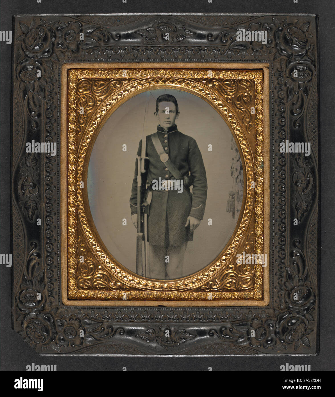 Unidentified soldier in Union frock coat with musket and attached sword ...