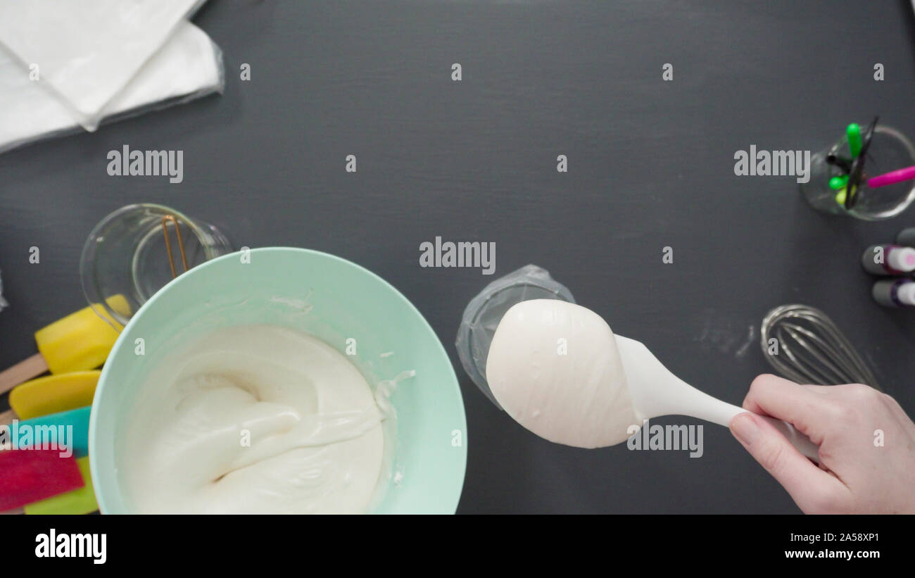 Step by step. Flat lay. Pouring royal icing into the piping bag to ...